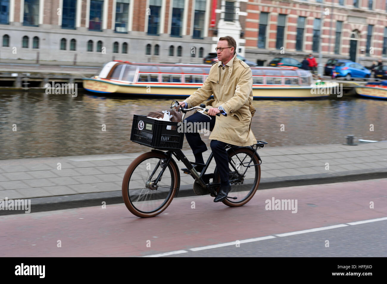 A male cyclist on the street on Amsterdam, Holland, Netherlands. There ...