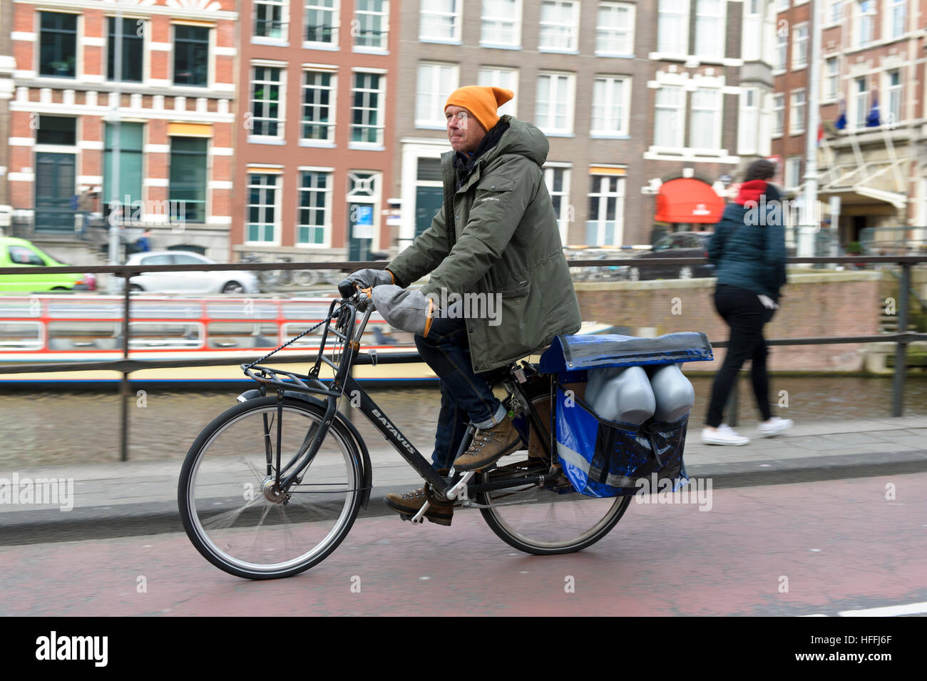A male cyclist on the street on Amsterdam, Holland, Netherlands. There ...