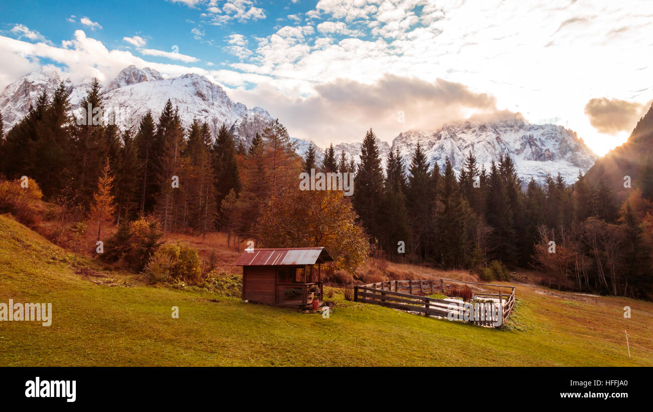 an alpine hut in the valley during a colorful sunset Stock Photo - Alamy