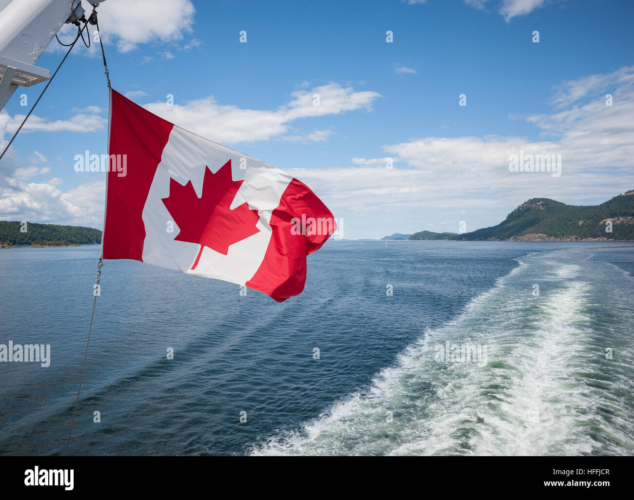 Canadian Flag over sea with wash from stern of boat Stock Photo - Alamy
