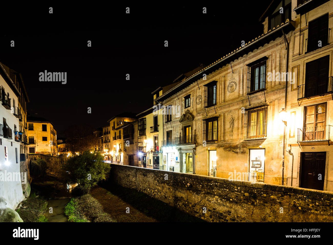 Urban scene of a river crossing the old part of the city of Granada ...