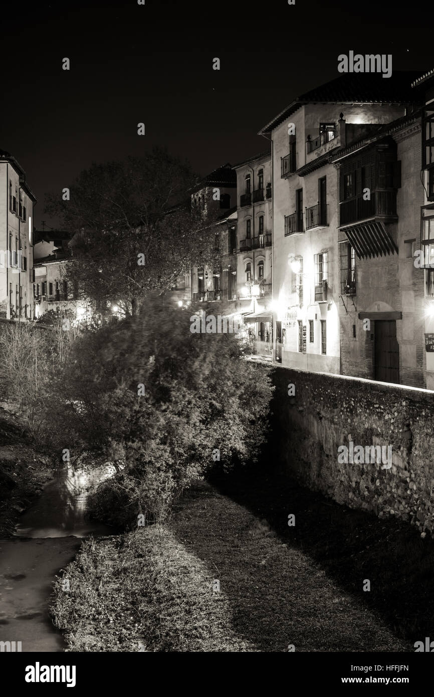 Urban scene of a river crossing the old part of the city of Granada ...