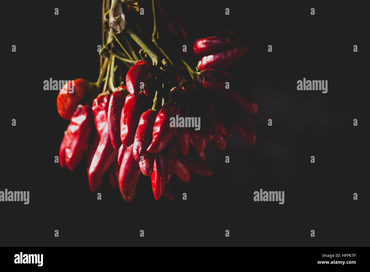 Bunch of Red Hot Peppers on Dark Background Stock Photo - Alamy