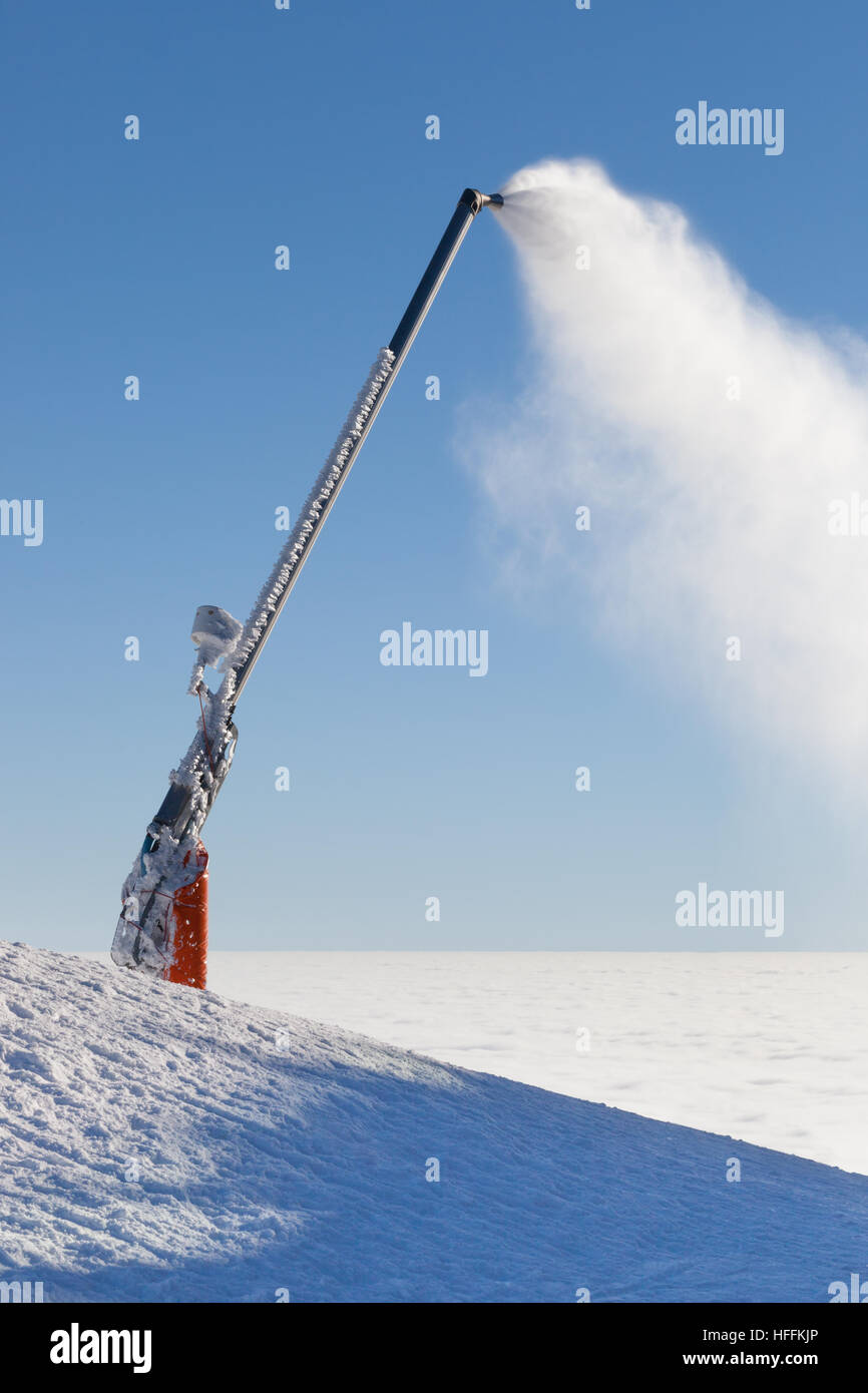 Snow cannon making artificial snow powder on a ski slope Stock Photo ...
