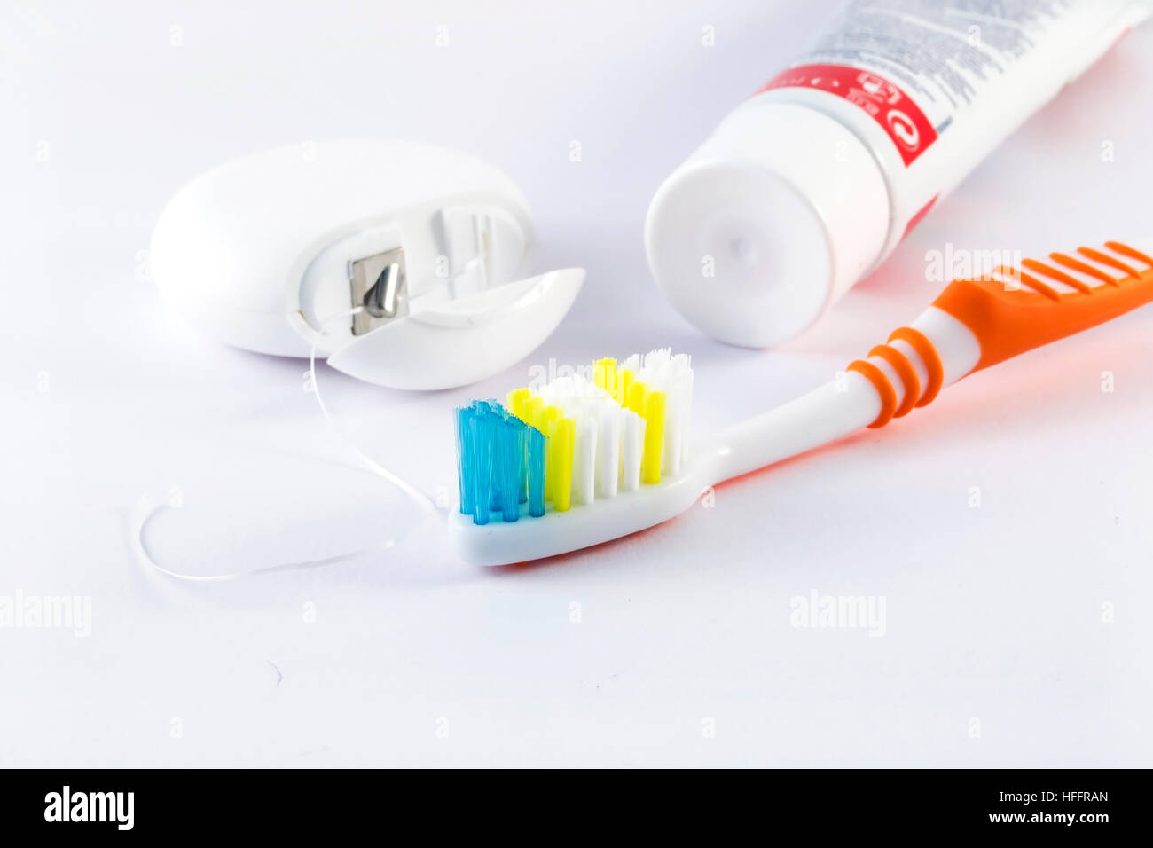 Toothbrush, dental floss and toothpaste on white background Stock Photo ...