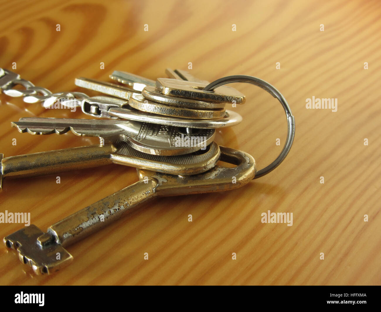 Bunch of worn house keys on wooden table Stock Photo - Alamy