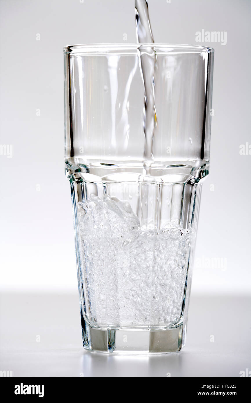 Pouring sparkling water into a glass Stock Photo - Alamy
