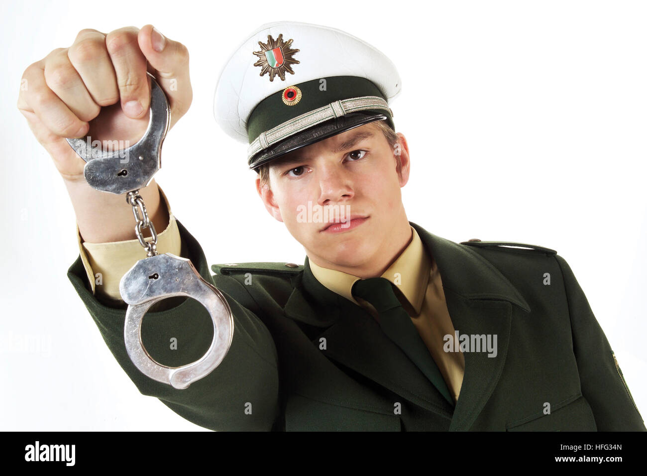 Young police officer holding handcuffs Stock Photo - Alamy Young police officer holding handcuffs Stock Photo - Alamy