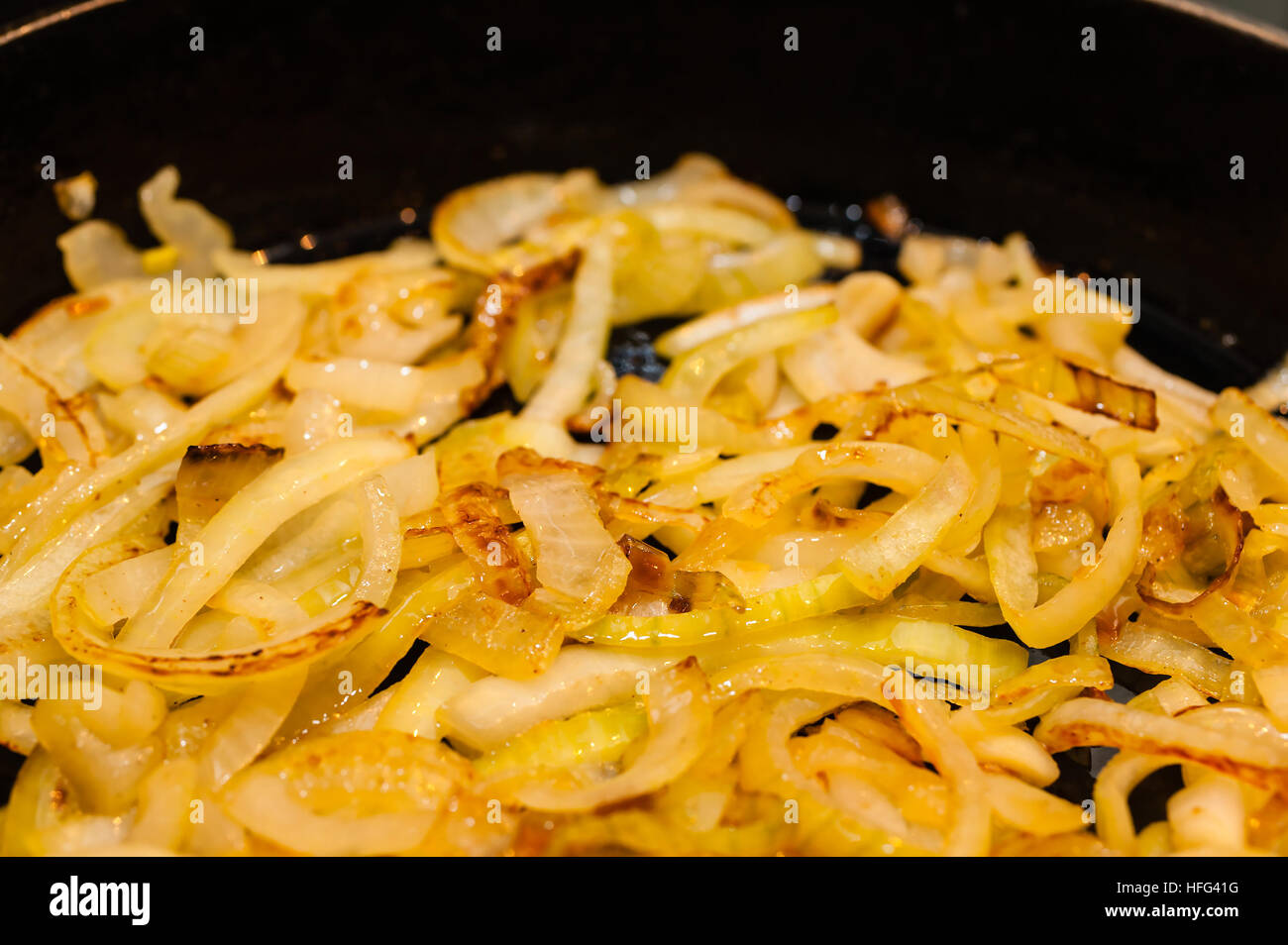 Golden brown sauteed onions in a cast iron skillet Stock Photo - Alamy