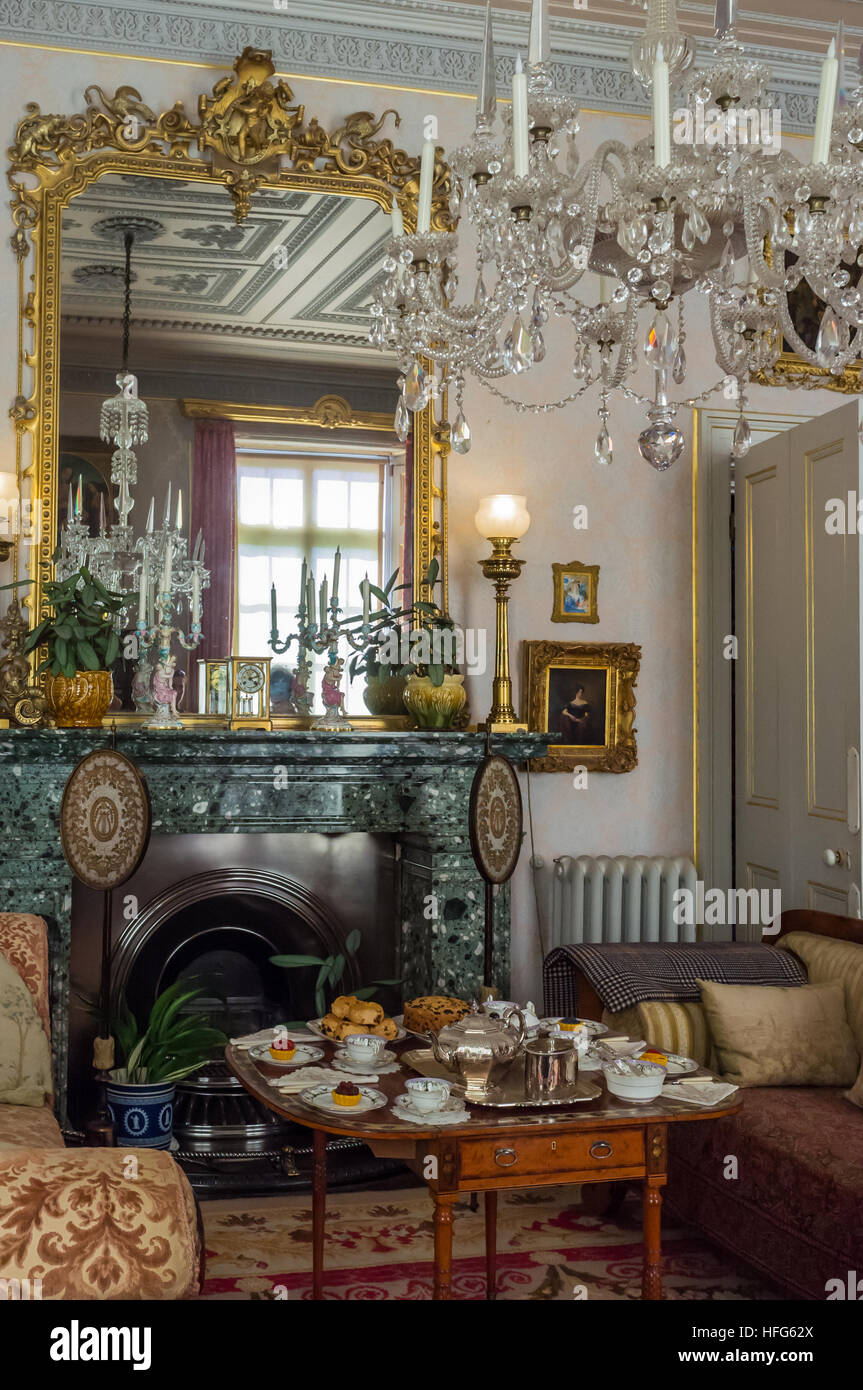 Traditional English country house scene of silver service tea and cakes ...