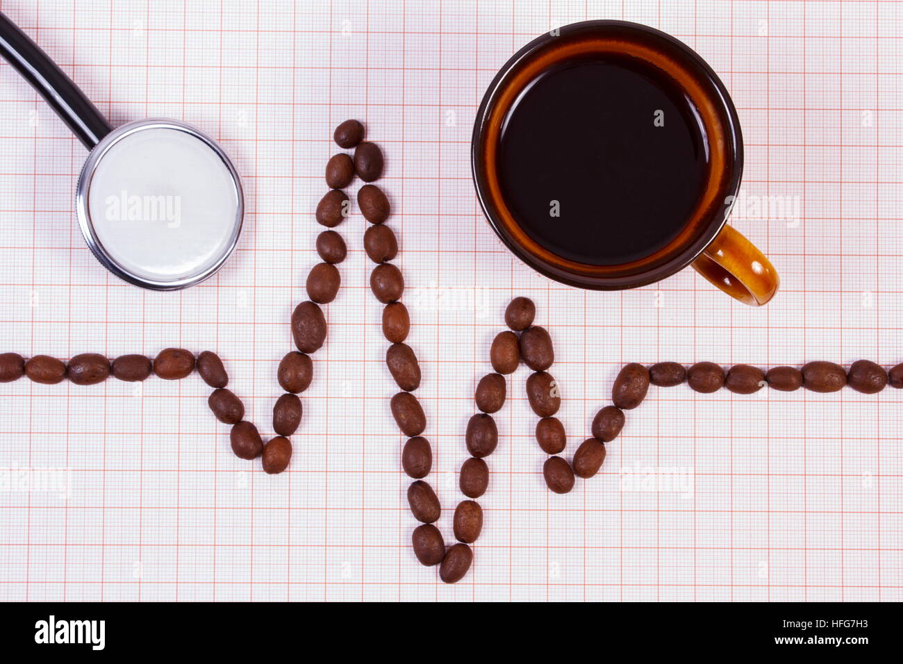 Electrocardiogram line of roasted coffee grains, cup of hot coffee and ...