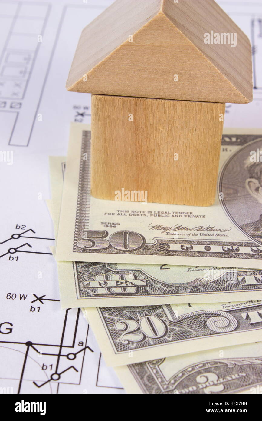 House shape made of wooden blocks and currencies dollar lying on ...