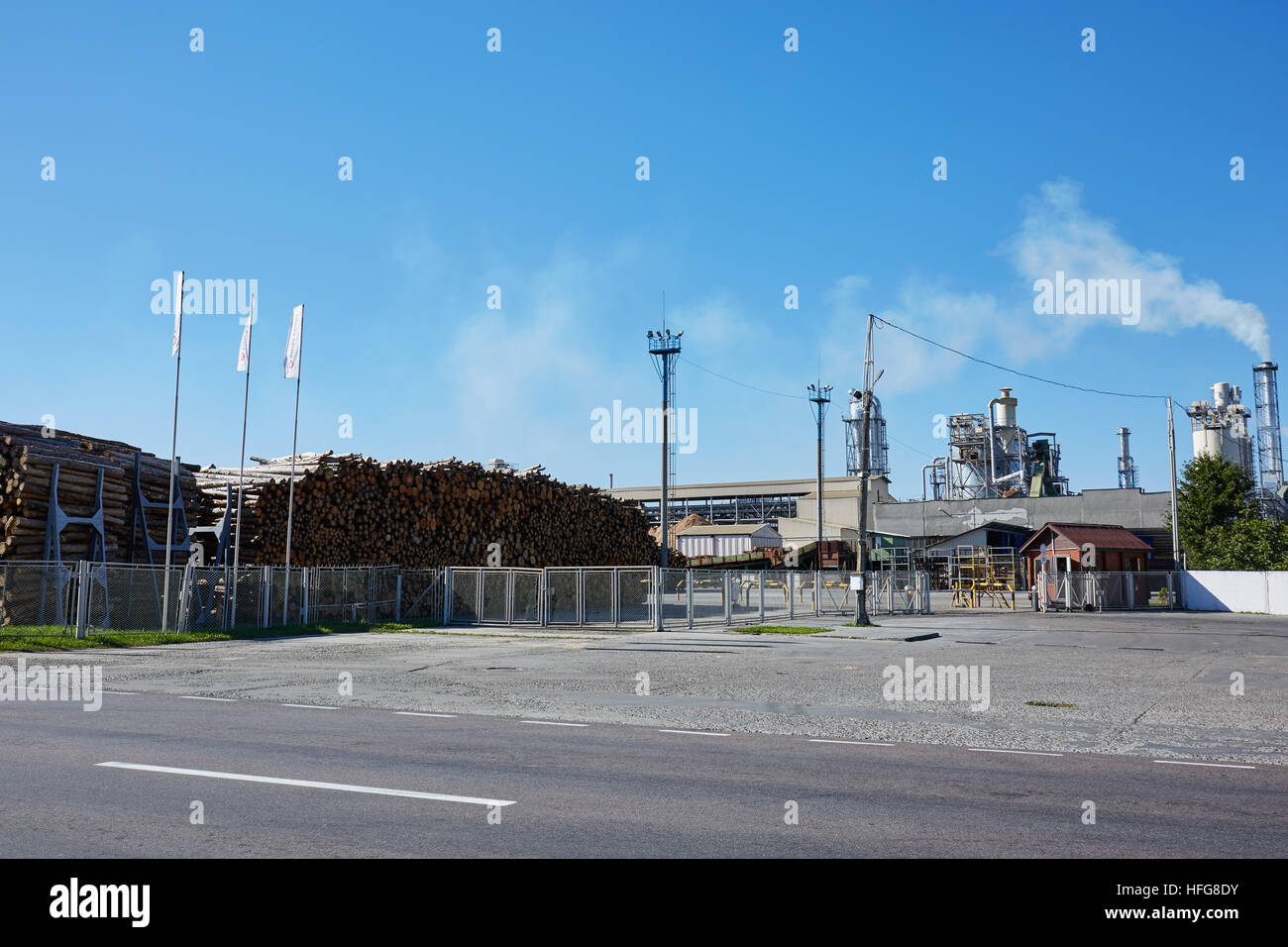 Wood factory with smoking chimneys Stock Photo - Alamy