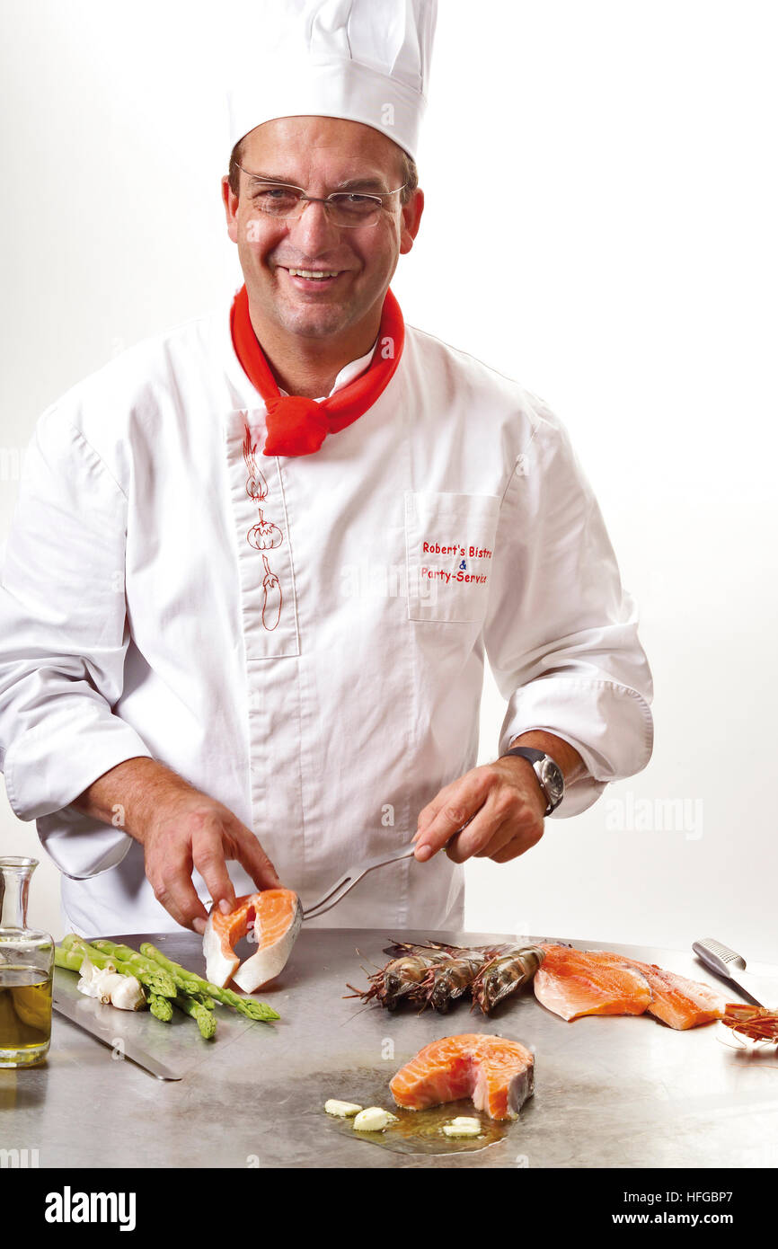 Chef grilling at a teppan grill, ingredients: trout, king prawns ...