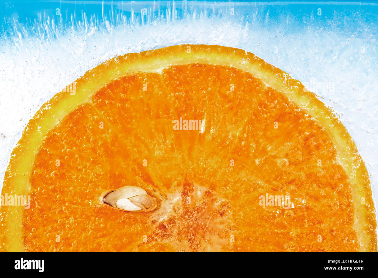 Orange frozen in a block of ice Stock Photo - Alamy