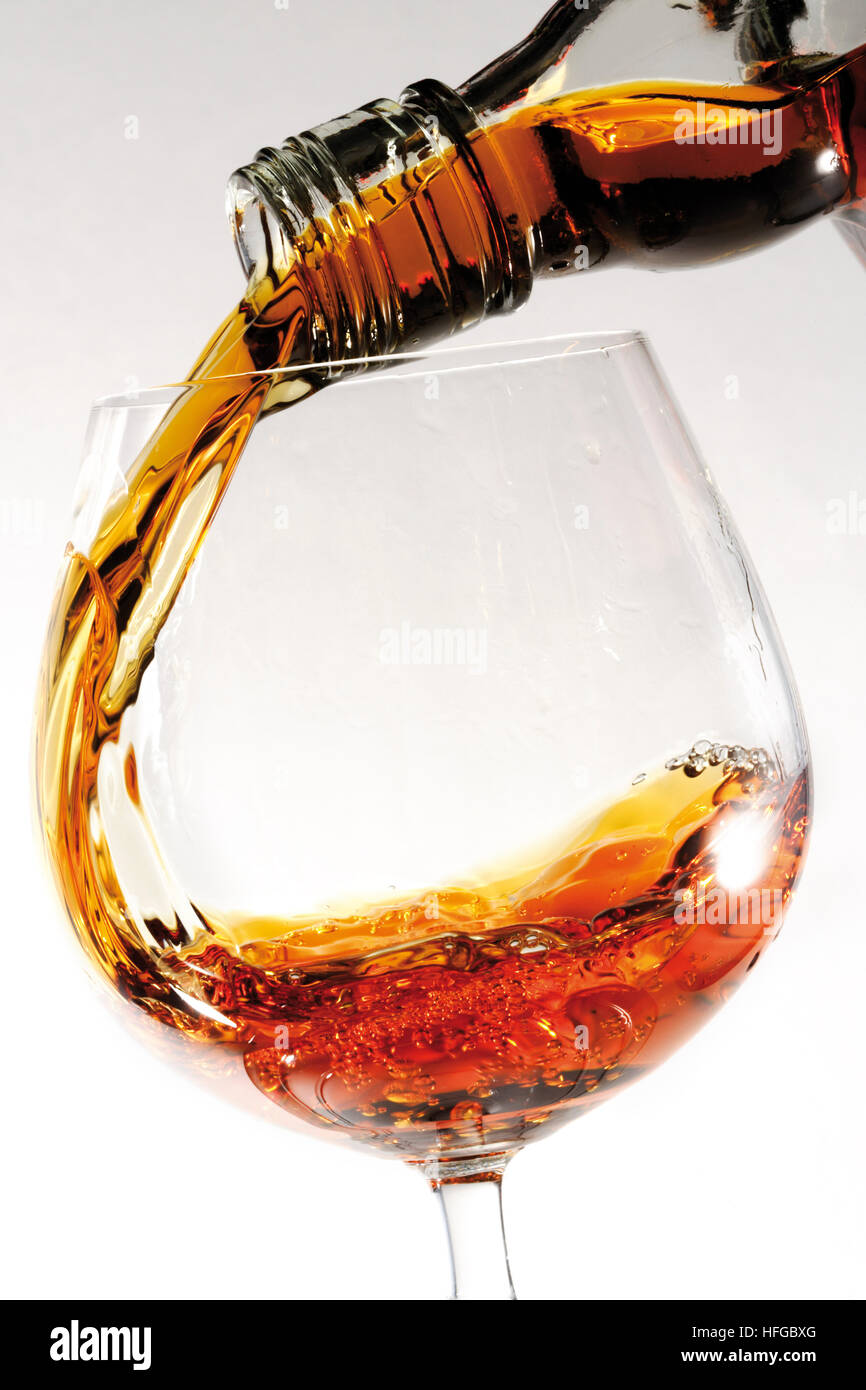 Pouring cognac into a glass Stock Photo - Alamy