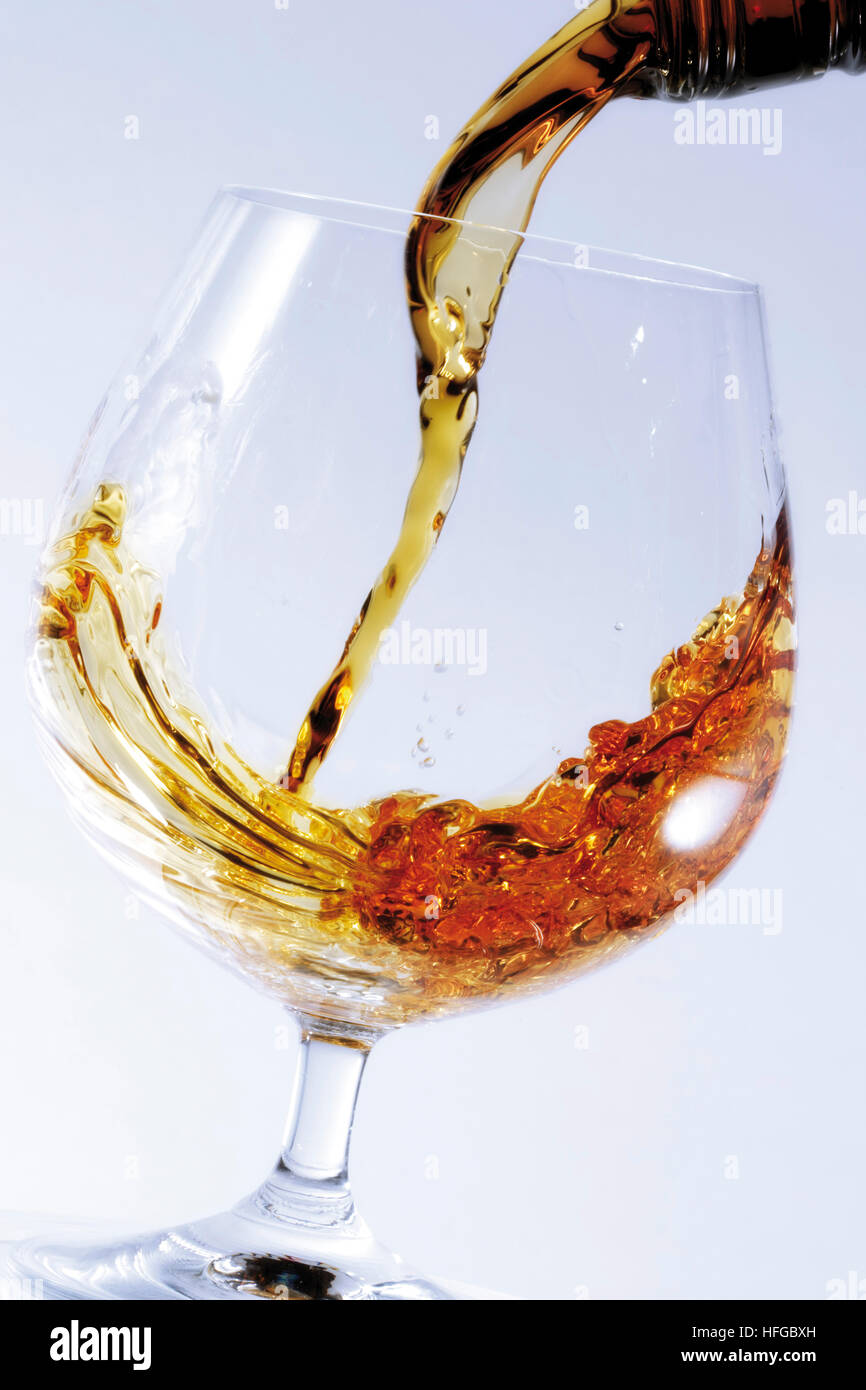 Pouring cognac into a glass Stock Photo - Alamy