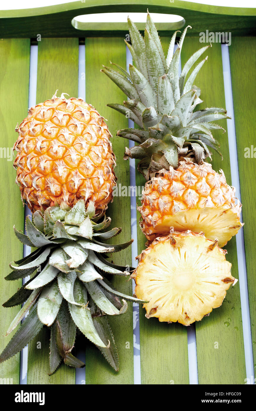 Two pineapples on a green tray Stock Photo - Alamy