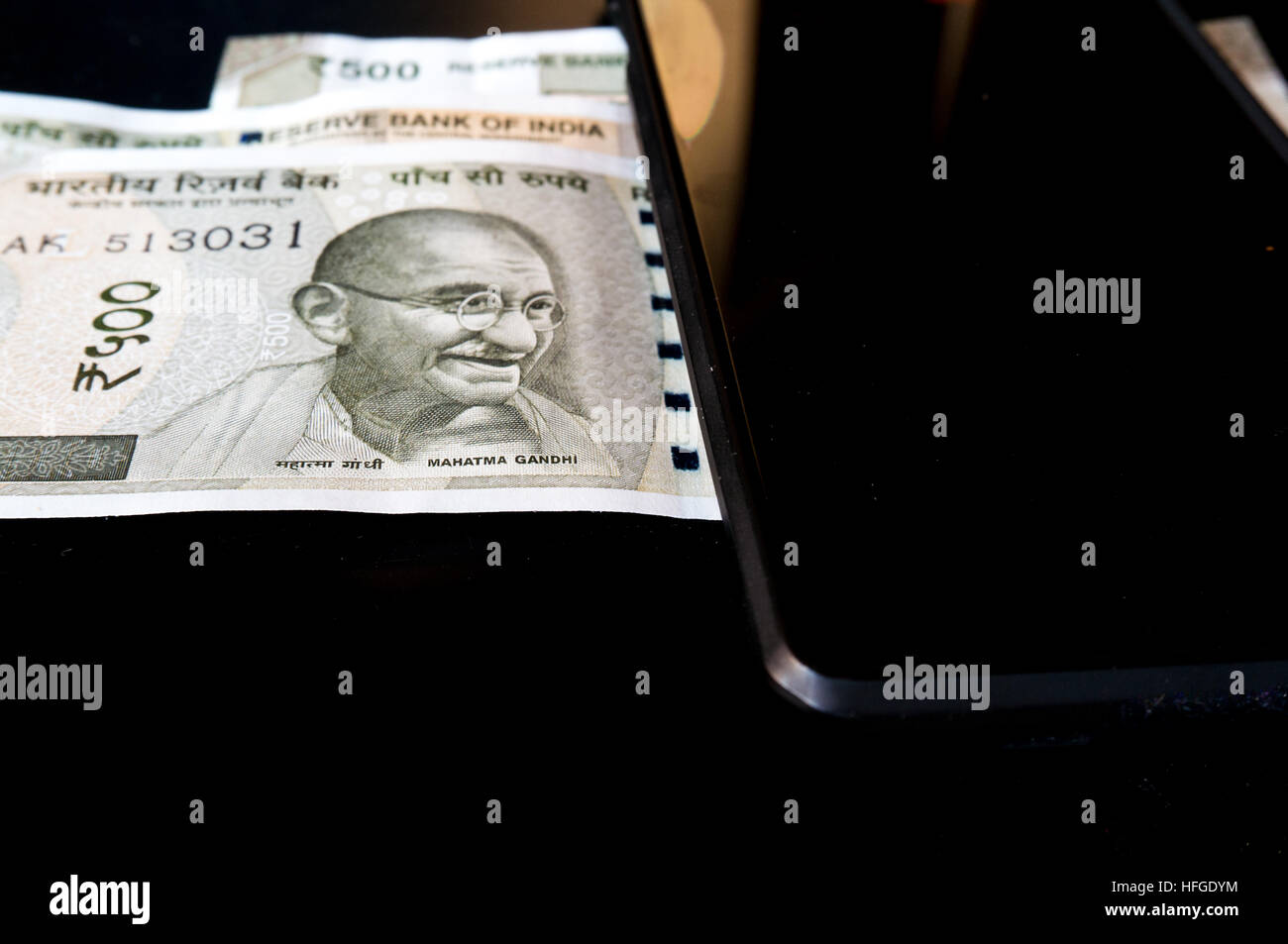 New Indian currency with a mobile device Stock Photo - Alamy