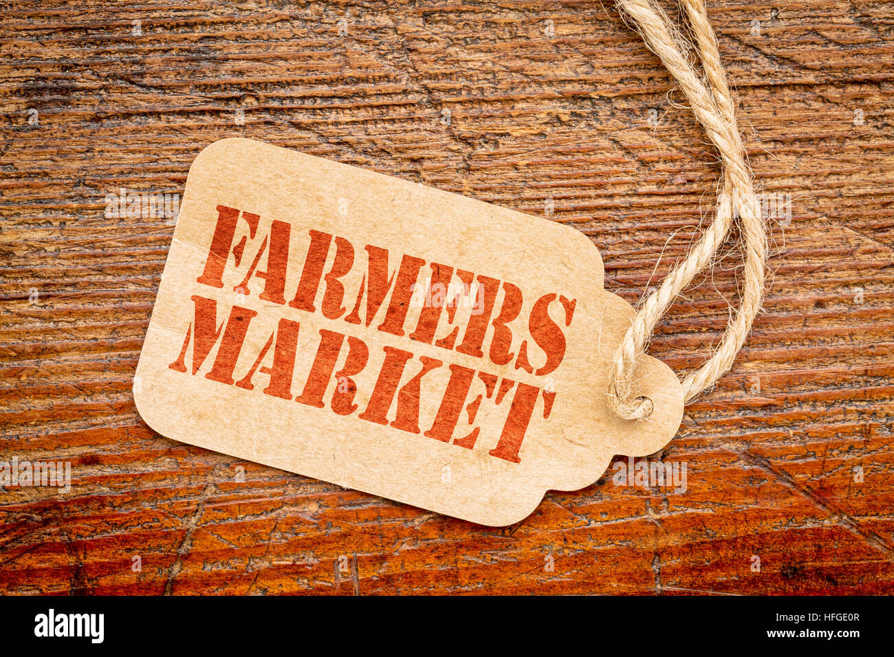 farmers market - red stencil text on a paper price tag against rustic ...
