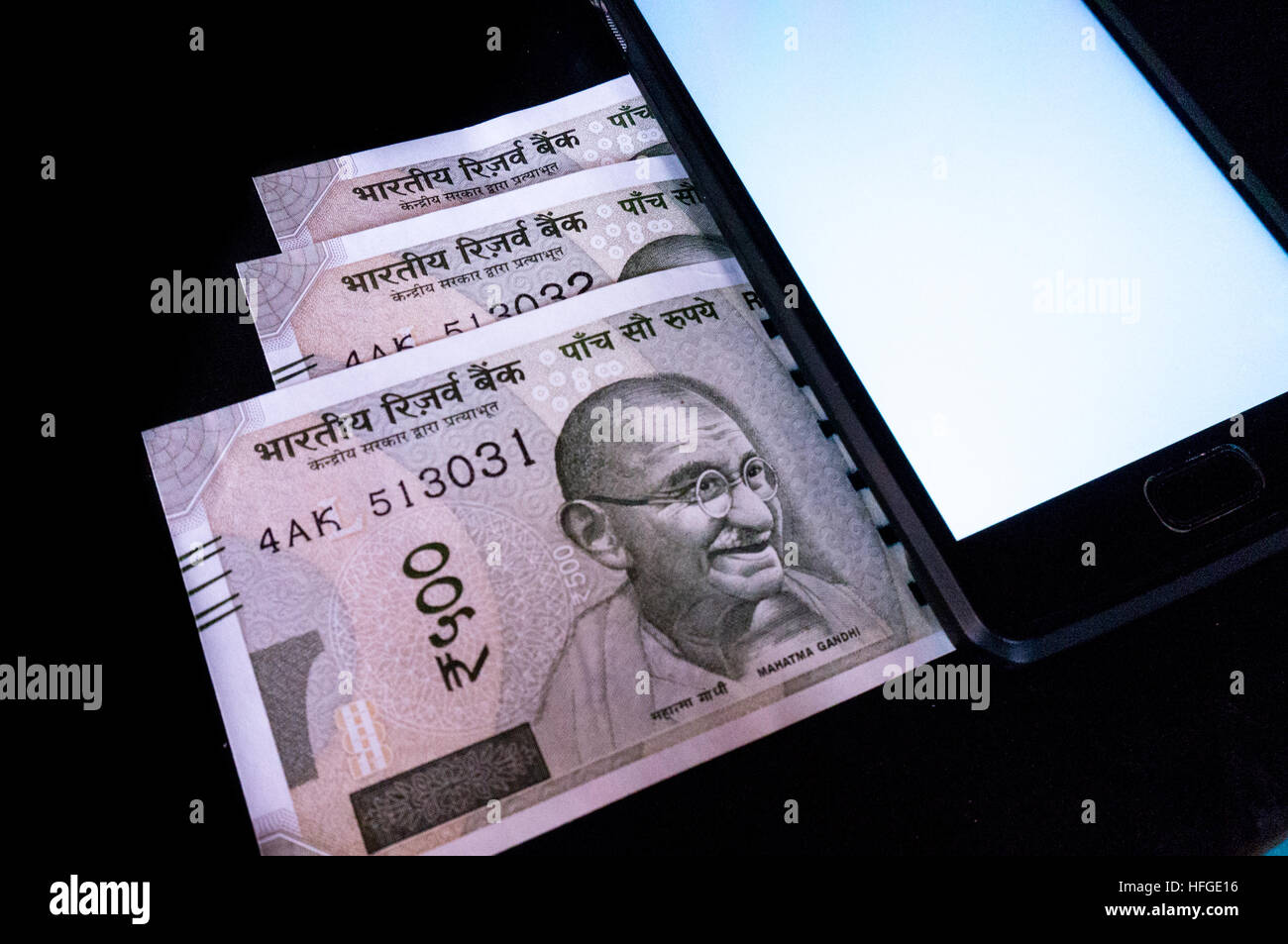 New Indian currency with a mobile device Stock Photo - Alamy