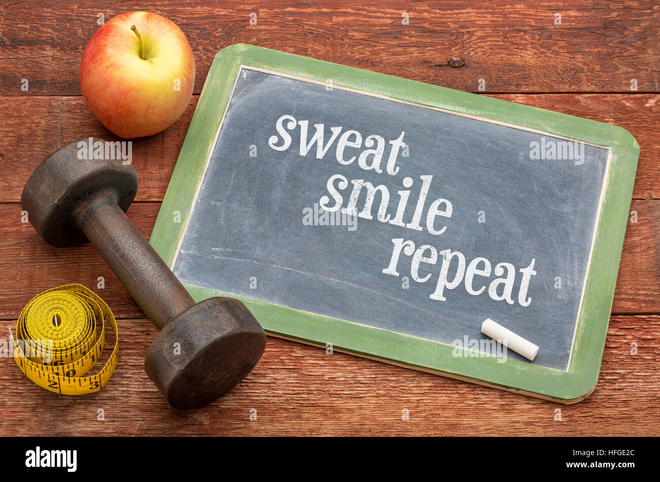 Sweat, smile, repeat - fitness concept - slate blackboard sign against ...