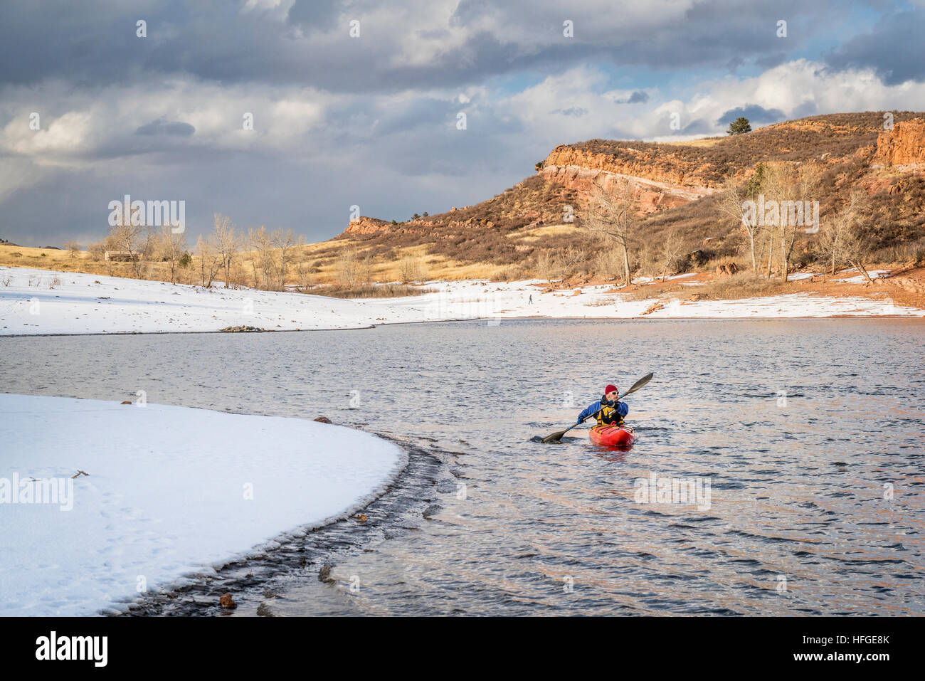 winter kayaking in Colorado - senior male paddler in a red whitewater ...