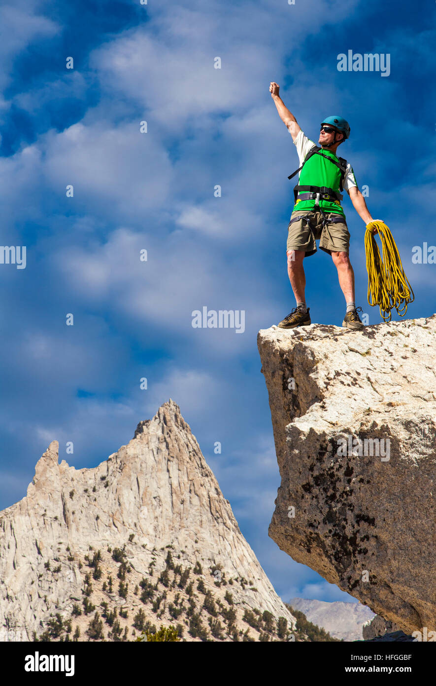 Male climber celebrates on the summit Stock Photo - Alamy