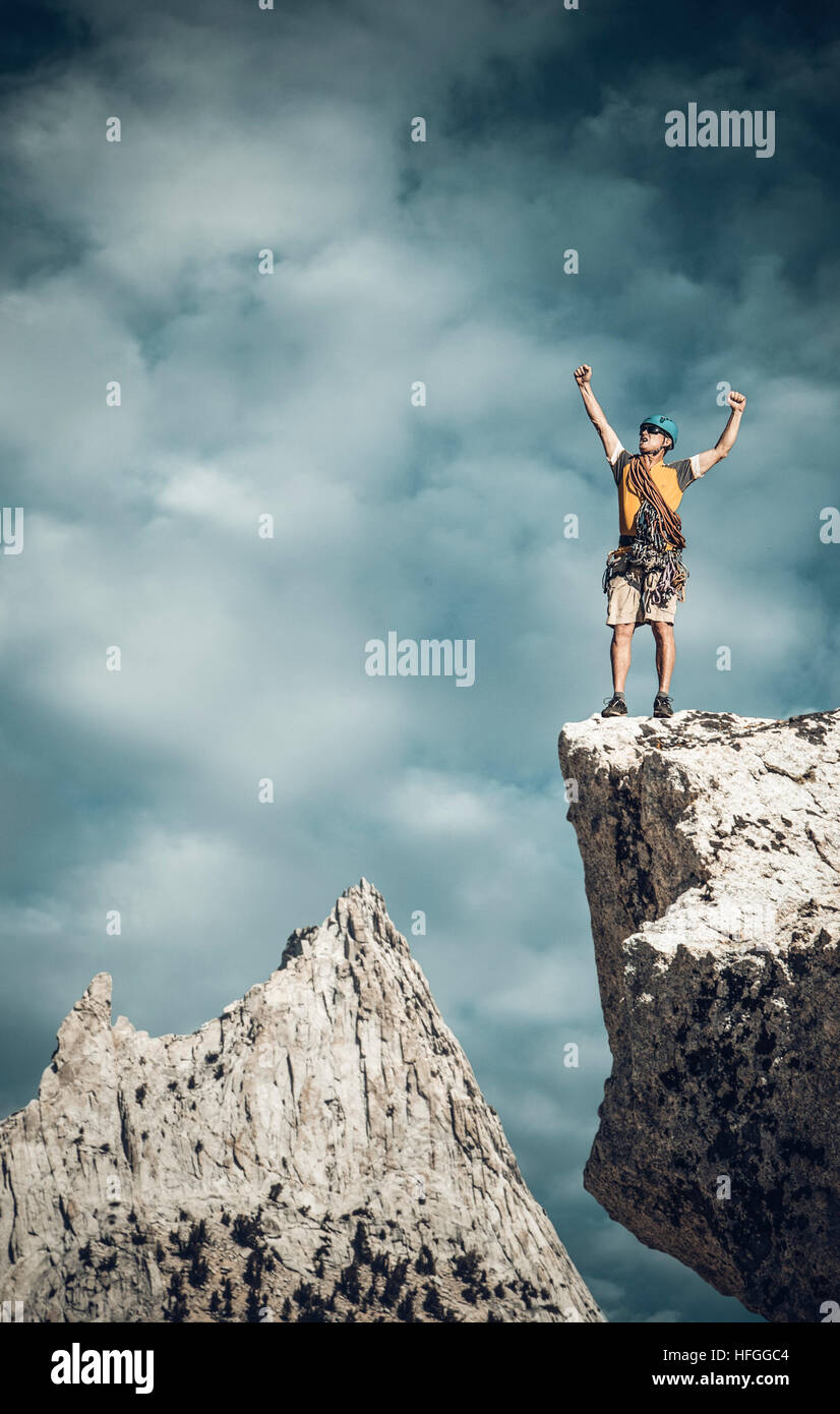 Male climber celebrates on the summit Stock Photo - Alamy