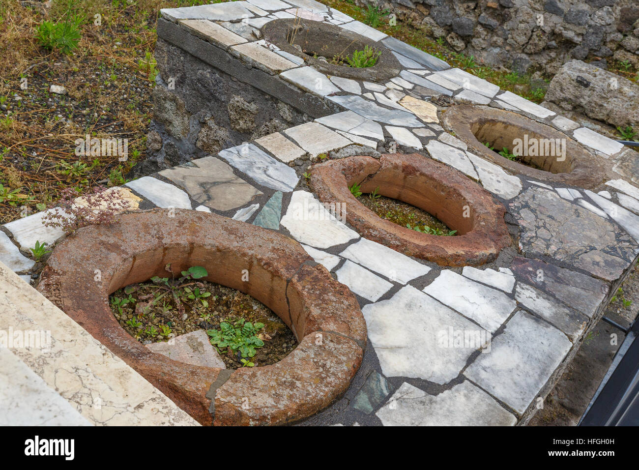 The site of a shop with it's counters in Pompeii, Southern Italy ...
