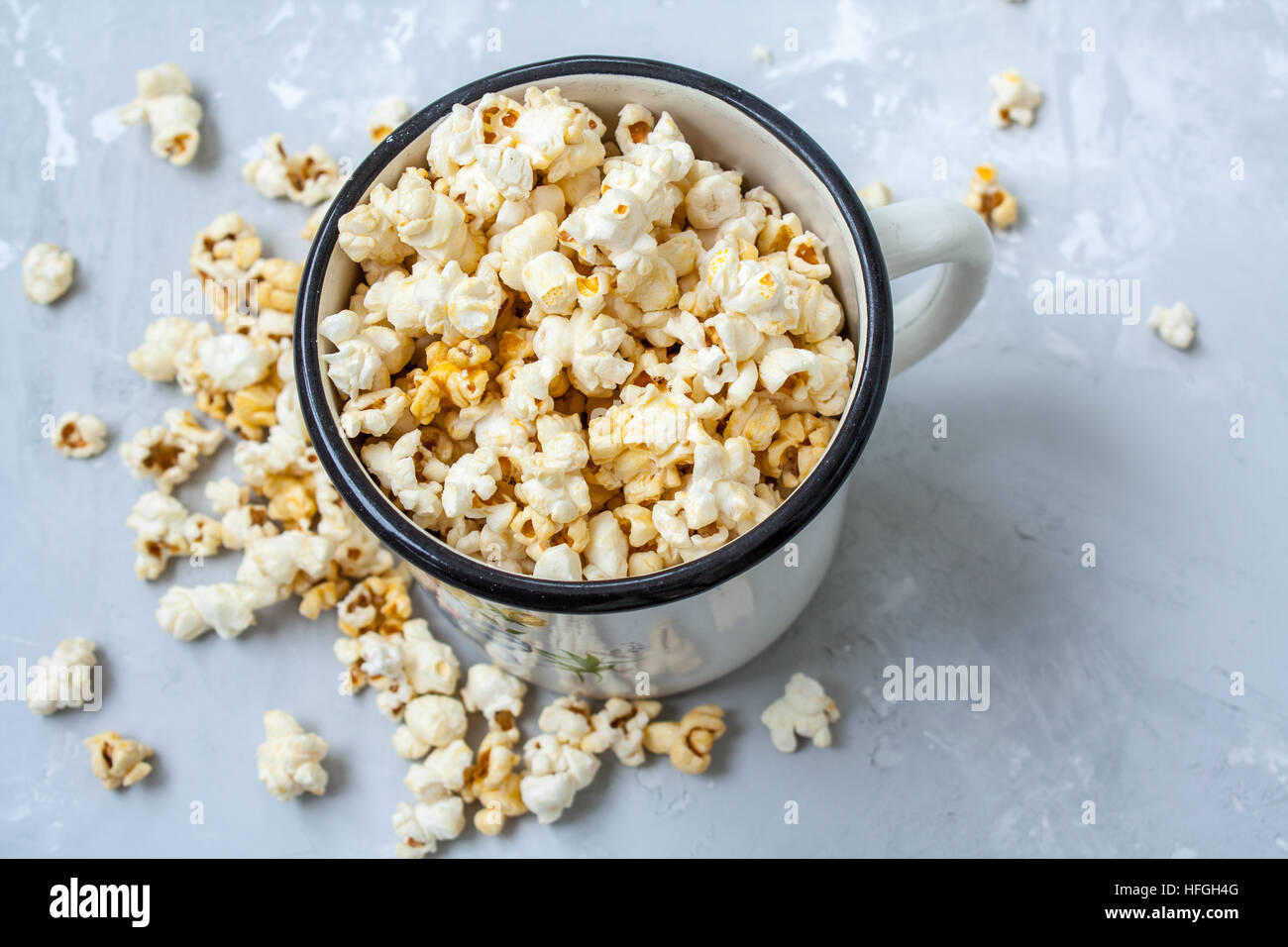 Sweet caramel popcorn in a large iron circle on the concrete gray ...
