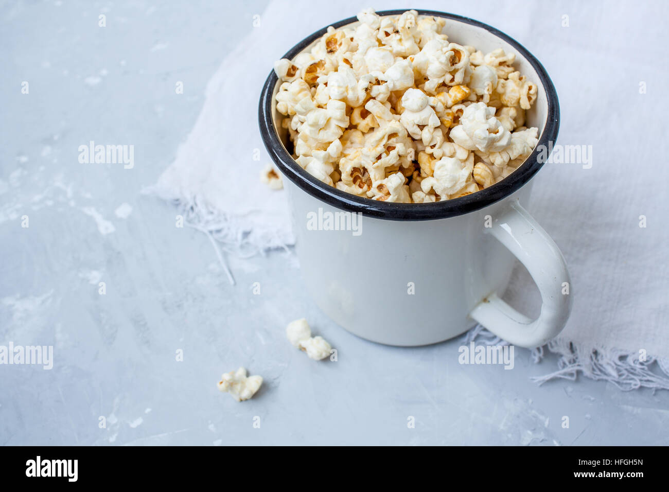 Sweet caramel popcorn in a large iron circle on the concrete gray ...