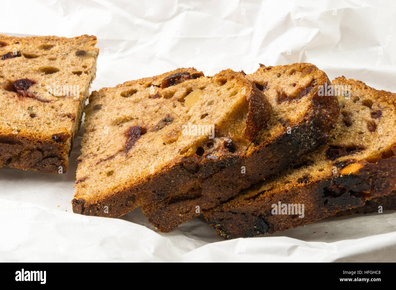 Slices of malt bread handmade with nuts, raisins and cranberries on ...