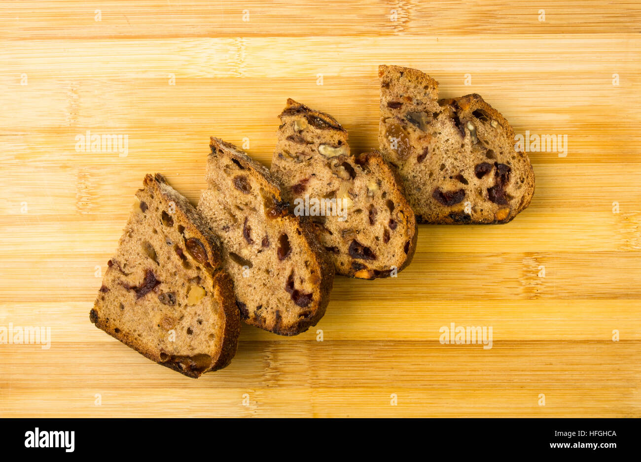 Slices of malt bread handmade with nuts, raisins and cranberries on ...