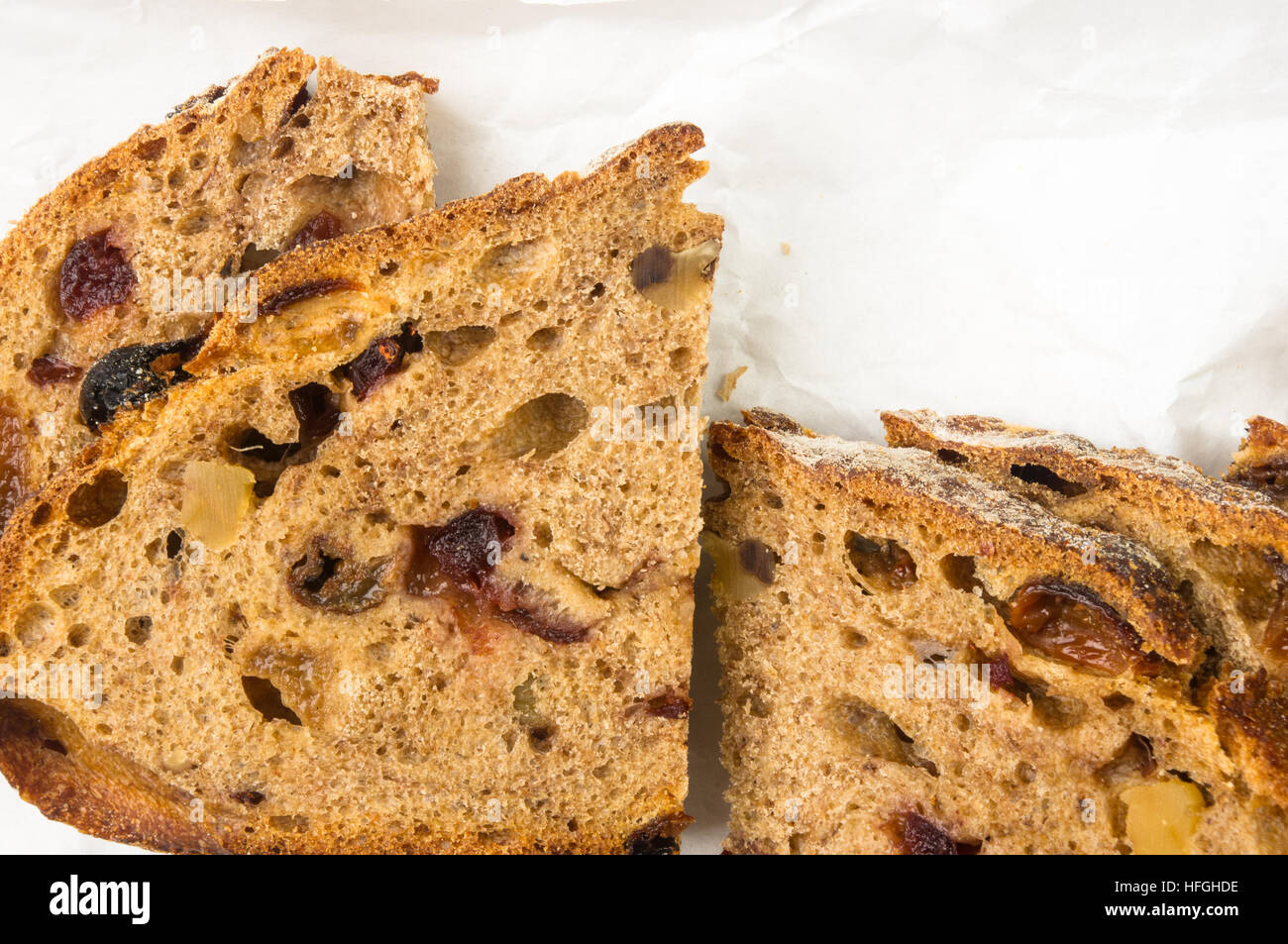 Slices of malt bread handmade with nuts, raisins and cranberries on ...