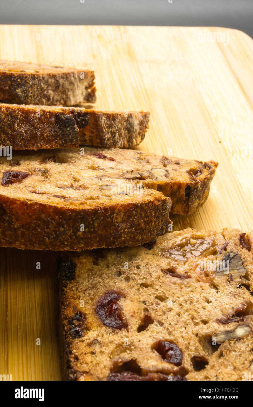Slices of malt bread handmade with nuts, raisins and cranberries on ...