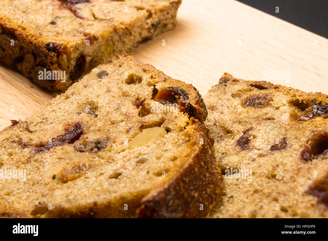 Slices of malt bread handmade with nuts, raisins and cranberries on ...