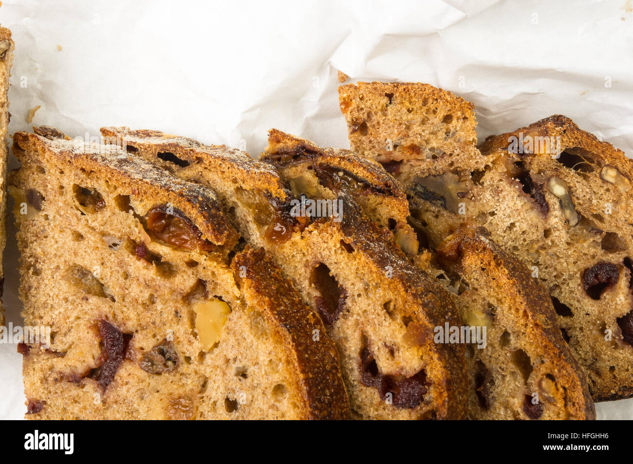 Slices of malt bread handmade with nuts, raisins and cranberries on ...