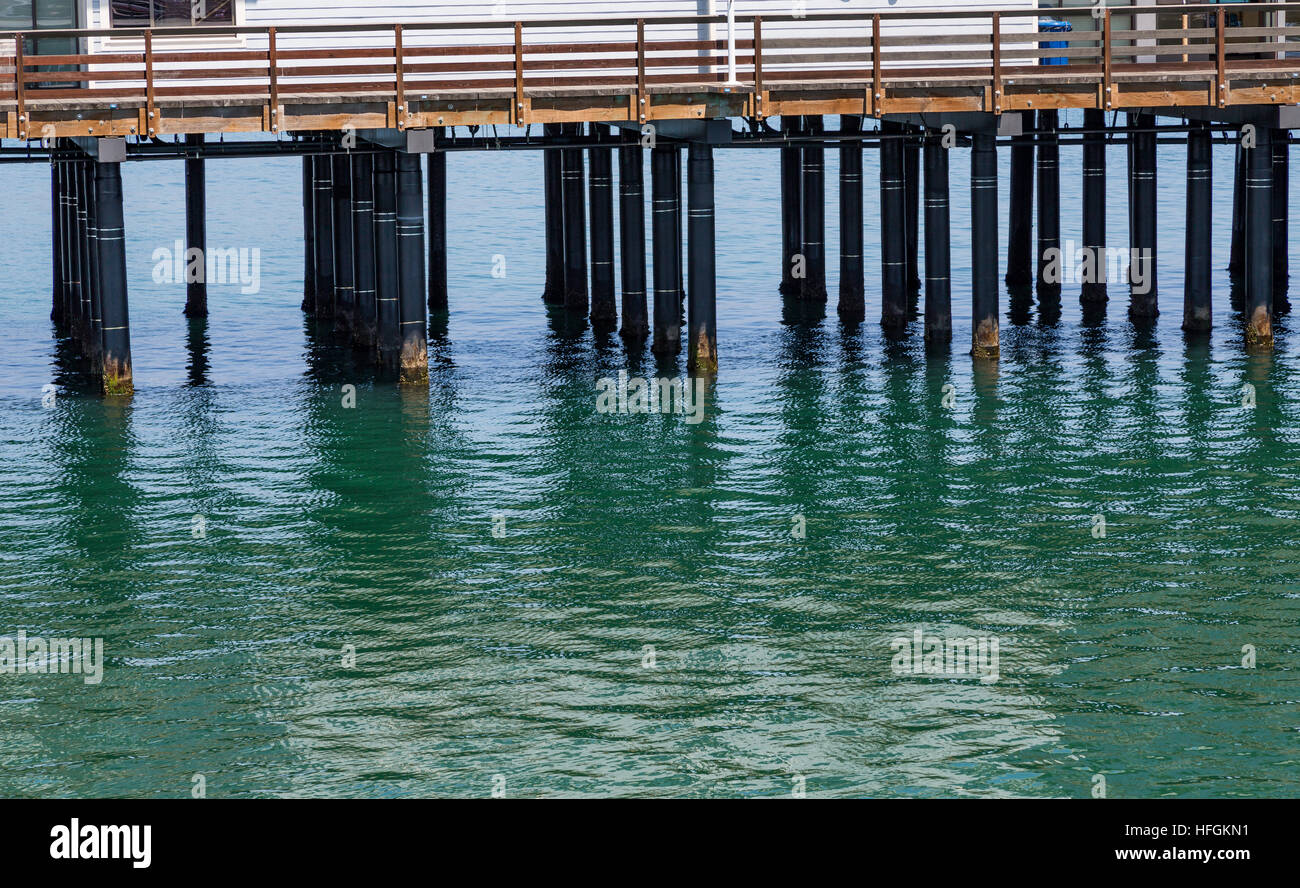 Steel Pier Pillars into Green Sea Stock Photo - Alamy