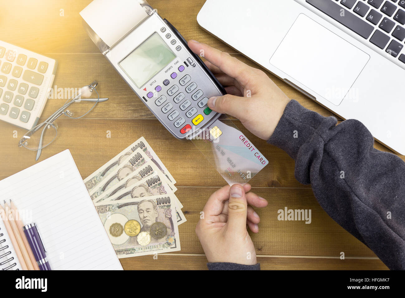 Cashier hand holding a Credit card over EDC machine or credit card ...