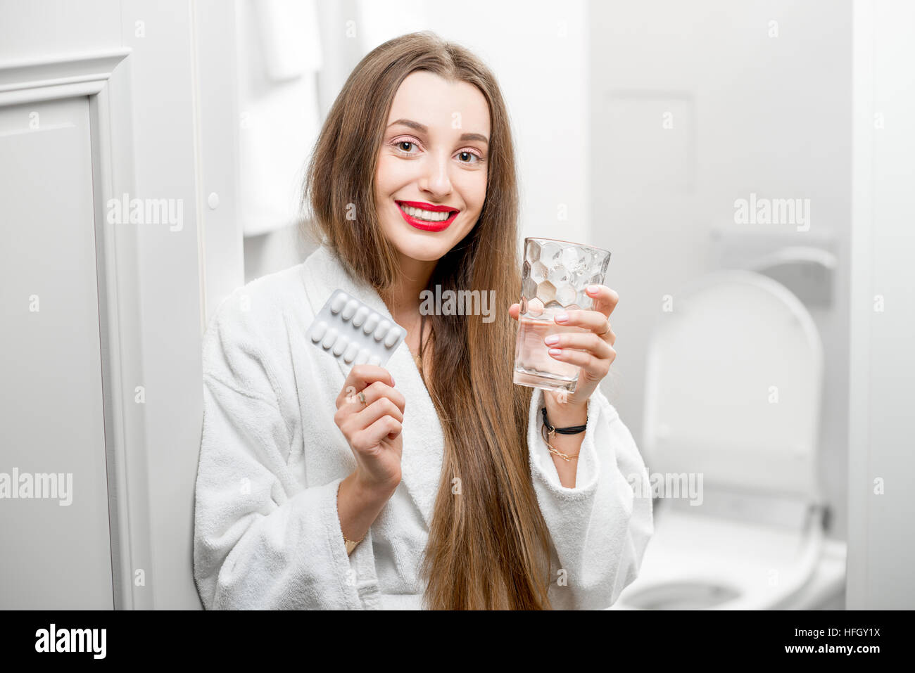 Happy adult woman taking pills hi-res stock photography and images - Alamy