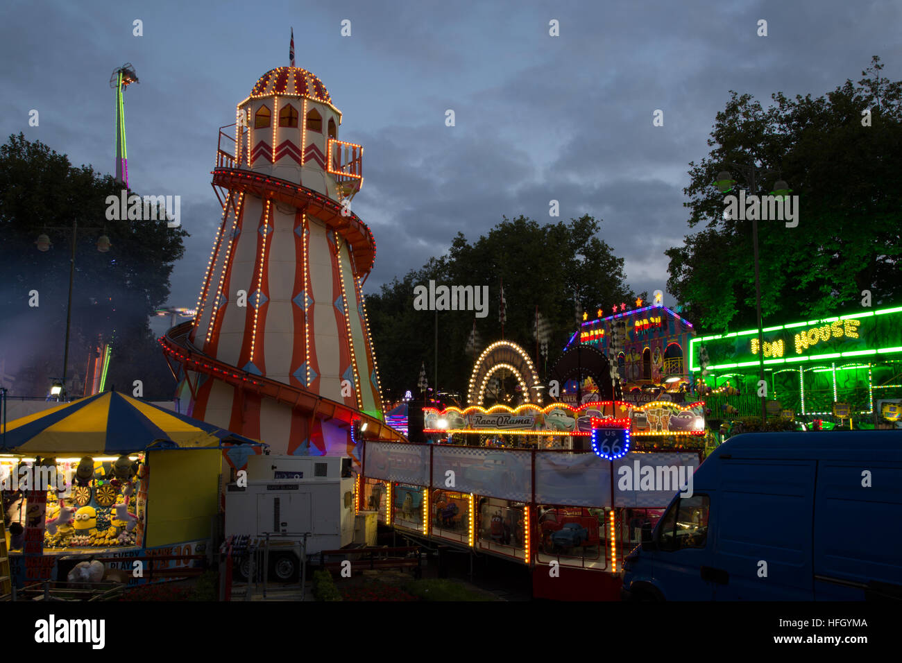 Fairground rides lit up at dusk Stock Photo - Alamy