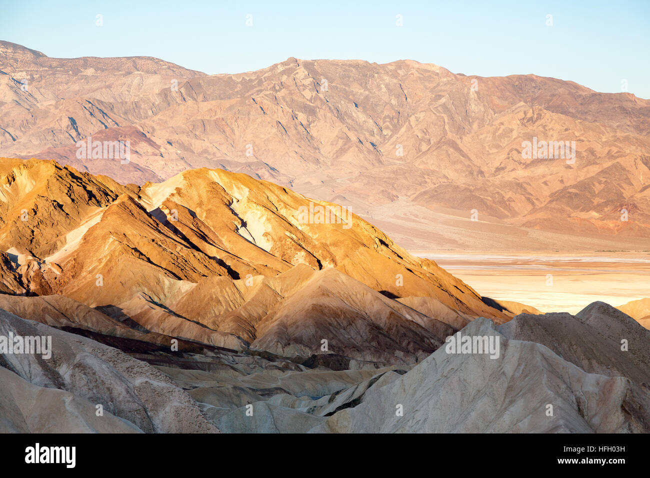Sun rising over Death Valley, showing the dramatic rocks formations and ...