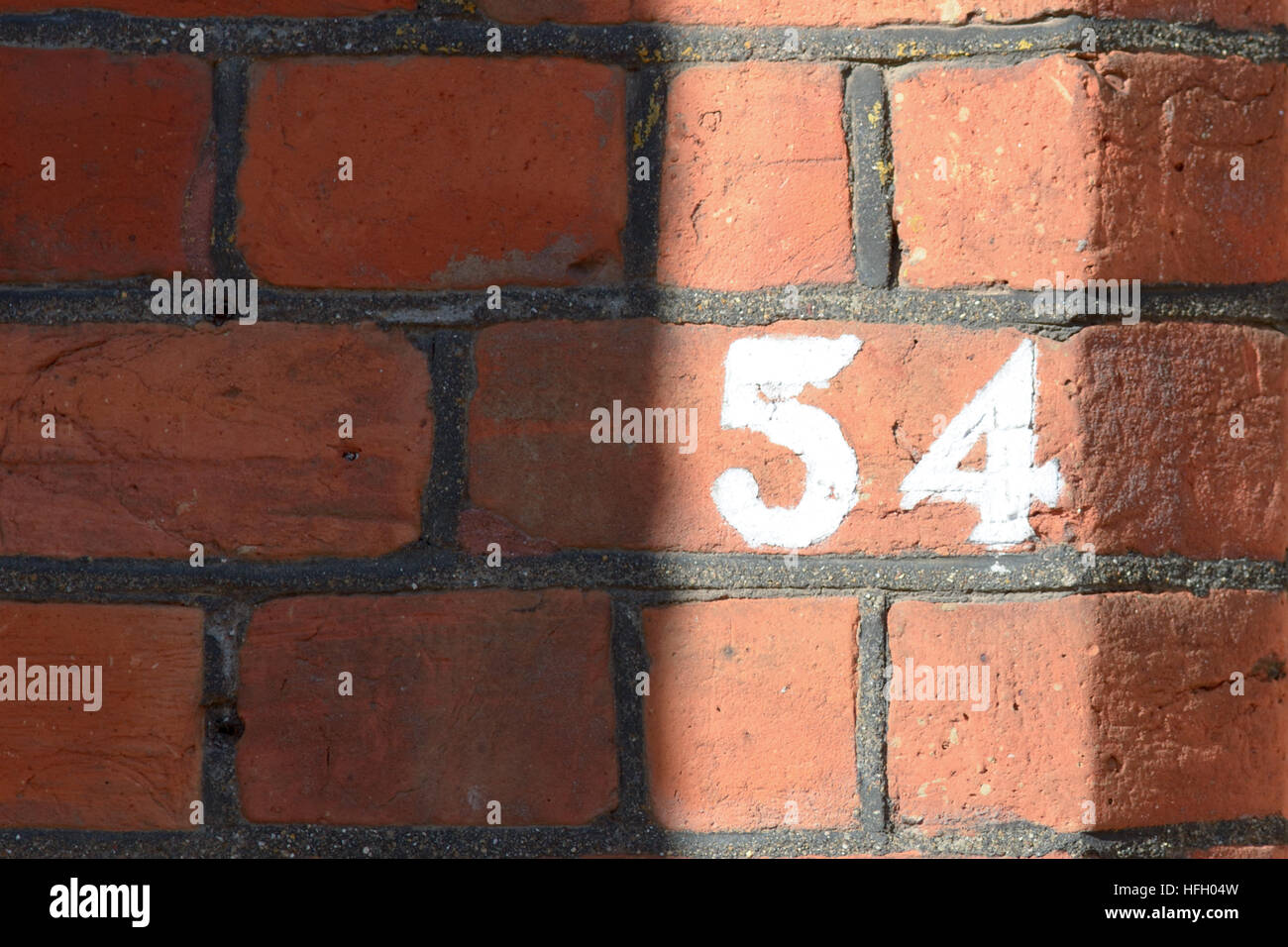 House Number 54 painted sign on wall Stock Photo - Alamy