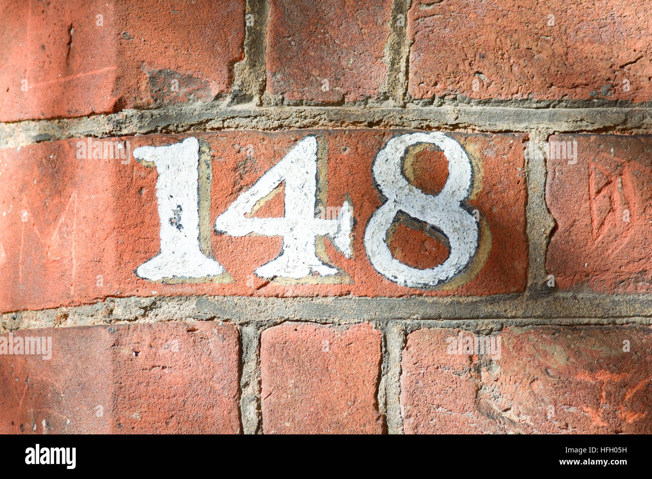 House Number 148 painted sign on wall Stock Photo - Alamy