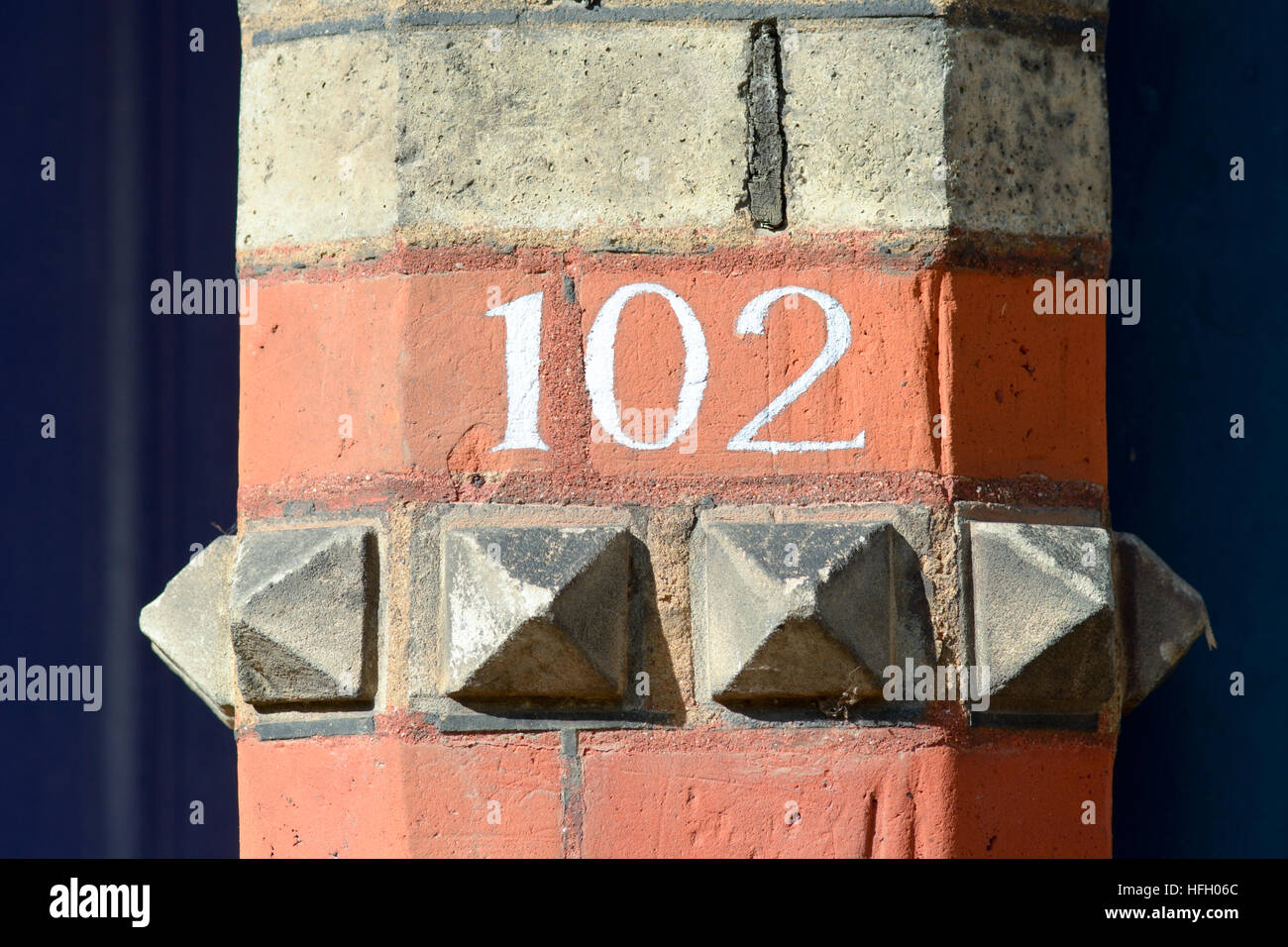 House Number 102 painted sign on wall Stock Photo - Alamy