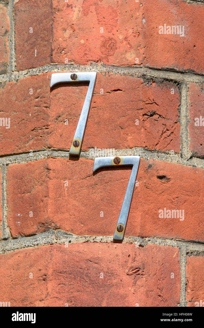 House Number 77 sign on wall Stock Photo - Alamy