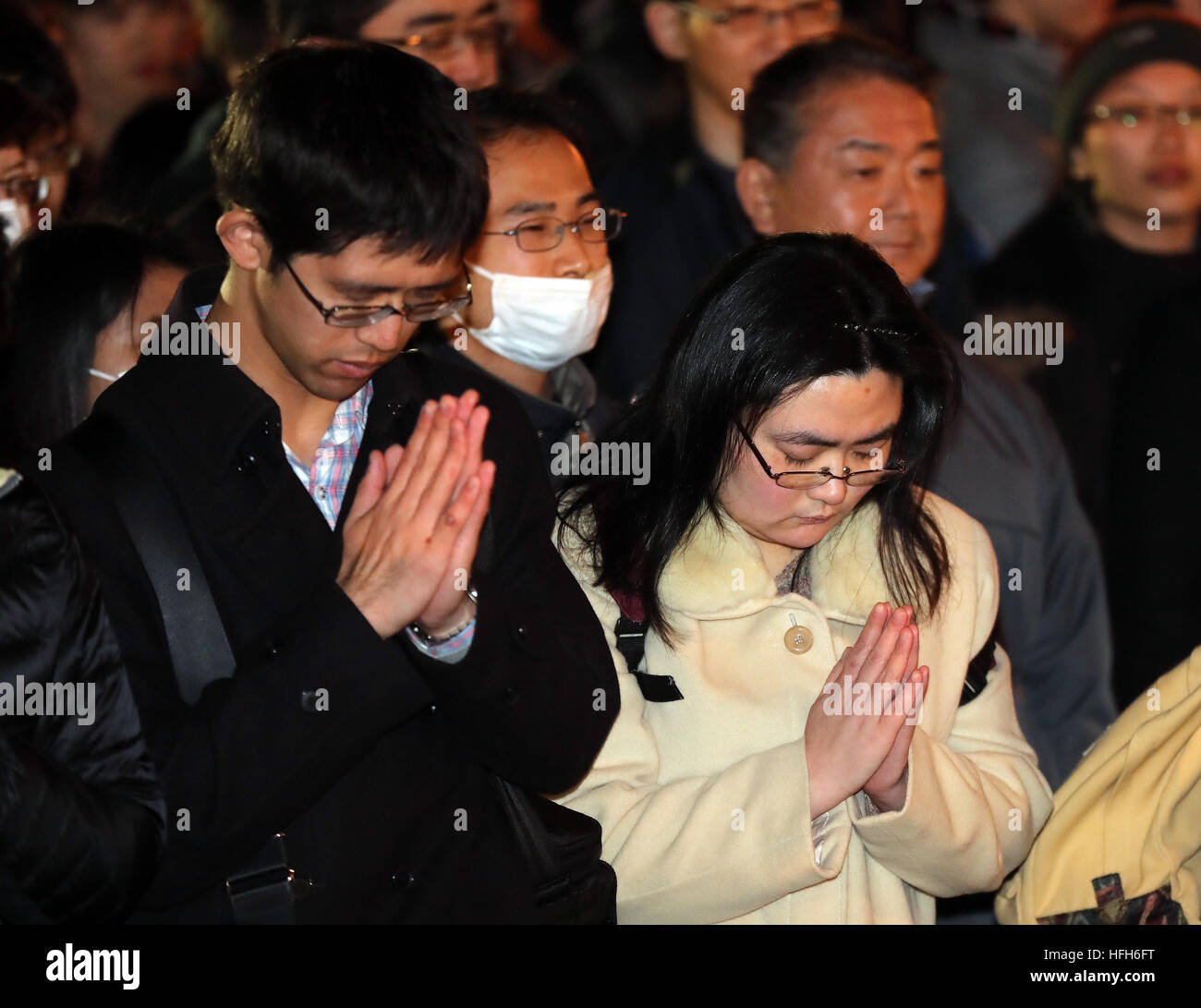 Tokyo, Japan. 1st Jan, 2017. Japanese worshippers pray as they ...