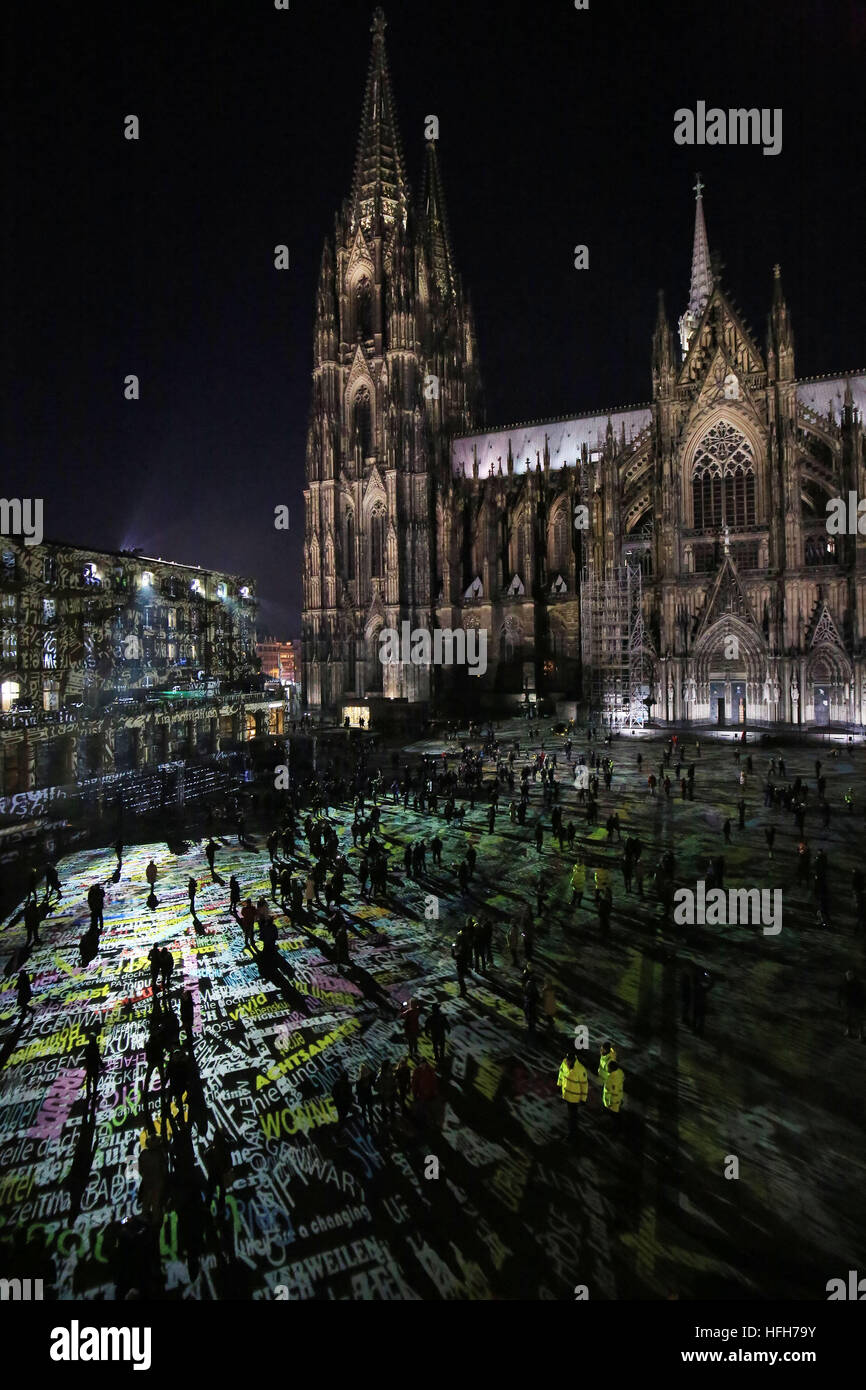 Cologne, Germany. 31st Dec, 2016. Tourists walk through a light ...