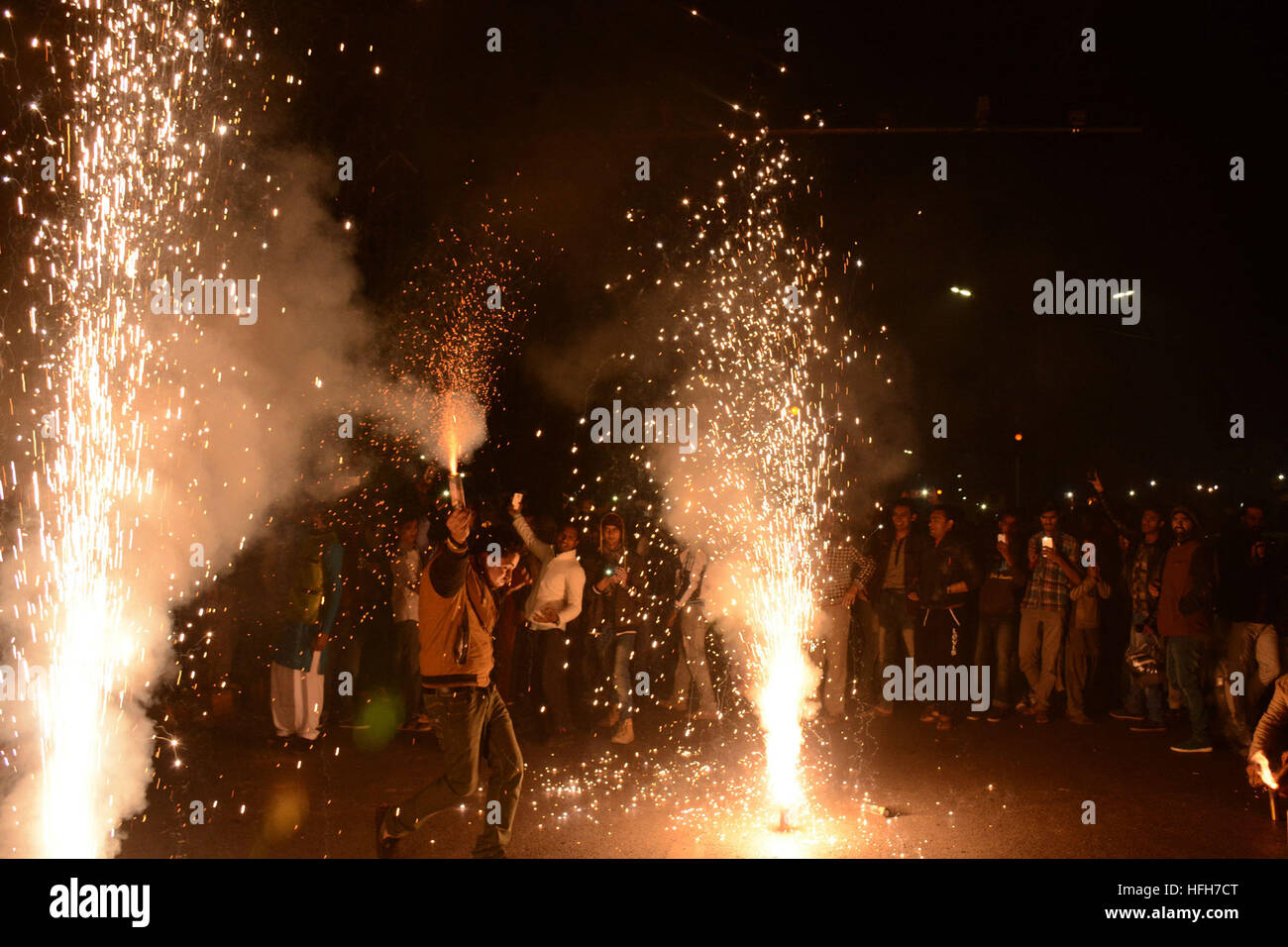 Lahore. 1st Jan, 2017. Pakistani youth set off firecrackers as they ...